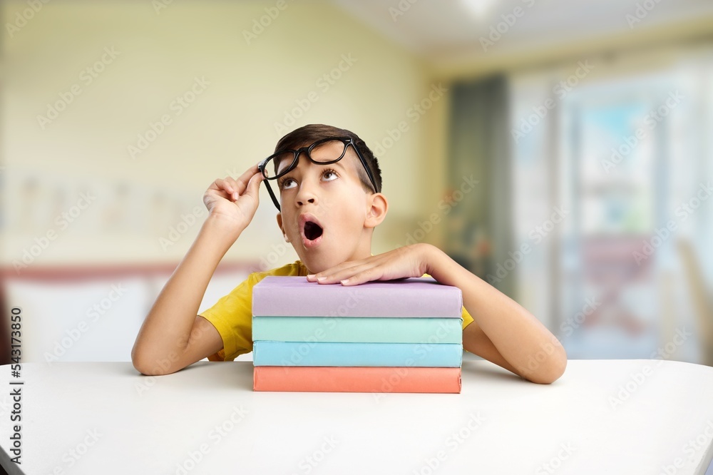 Cute kid study with books at home Stock Photo | Adobe Stock
