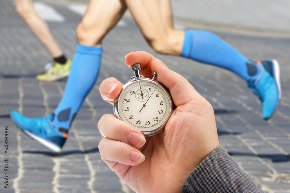 measuring the running speed of an athlete using a mechanical stopwatch ...