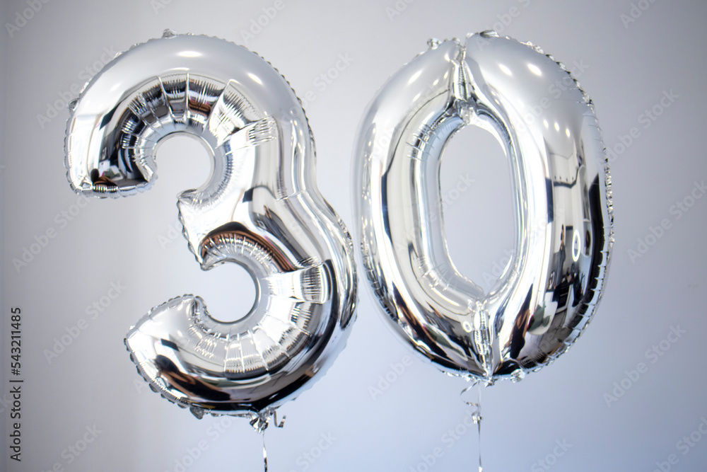 Silver color balloons with numbers 30 anniversary. Figures against a ...