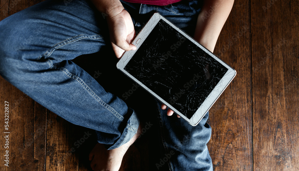 Portrait of a little Asian boy, Kid sad face, Unhappy child sitting holding broken tablet ...
