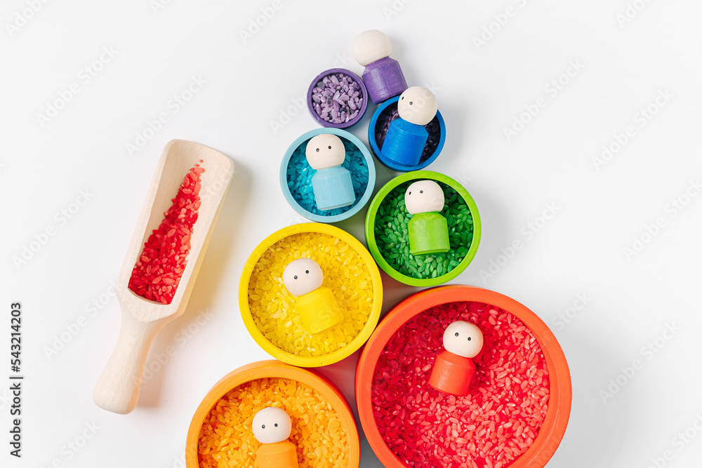 Bowls in rainbow colors with colored rice and scoops. Sensory bin ...