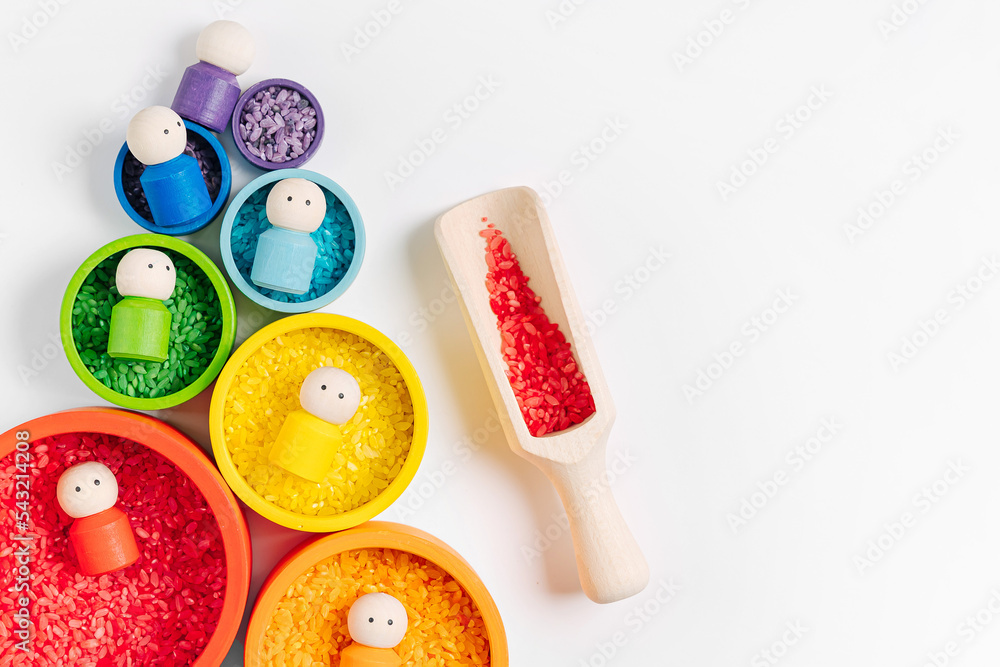 Bowls in rainbow colors with colored rice and scoops. Sensory bin ...