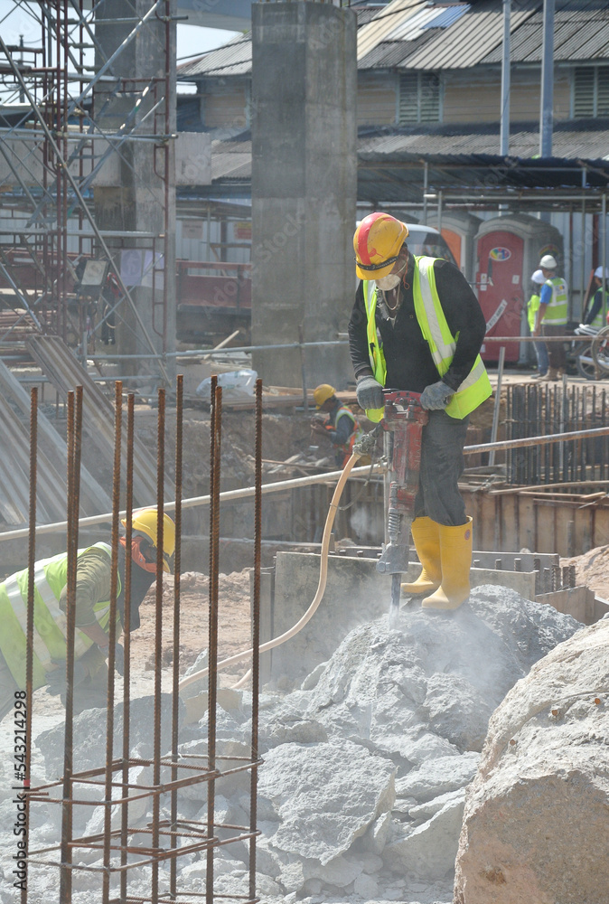 JOHOR, MALAYSIA -JANUARY 13, 2015: A construction workers cutting ...