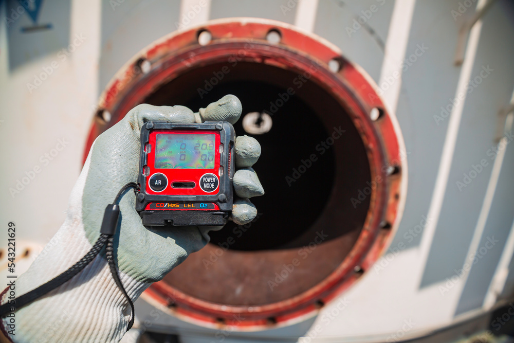 Worker hand holding gas detector inspection safety gas testing at front ...