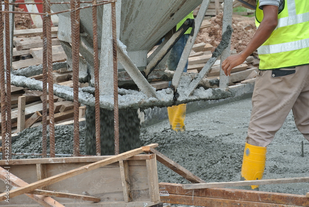 JOHOR, MALAYSIA -MAY 12, 2016: A group of construction workers pouring ...