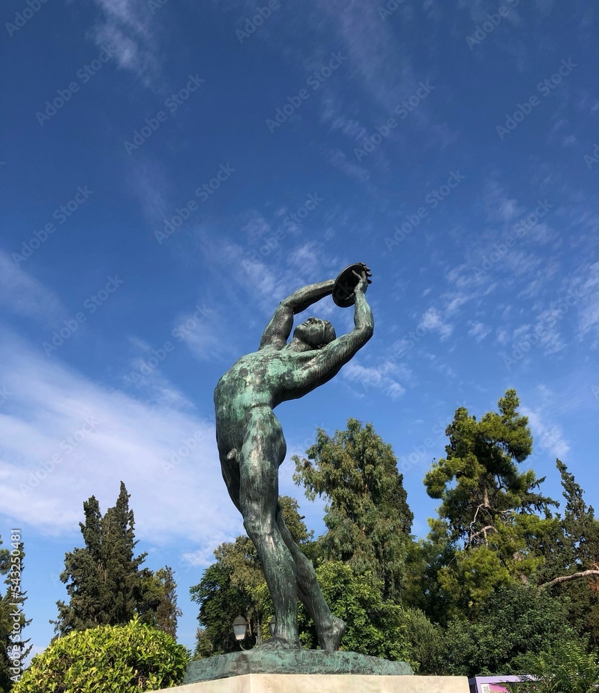 Vertical shot of the statue of Discobolus in front the Panathenaic ...