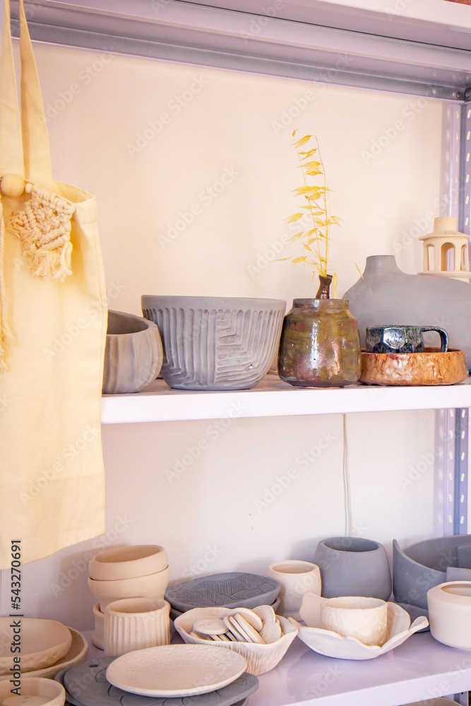 Handmade ceramic crockery and craft pottery. Inside interior of pottery ...