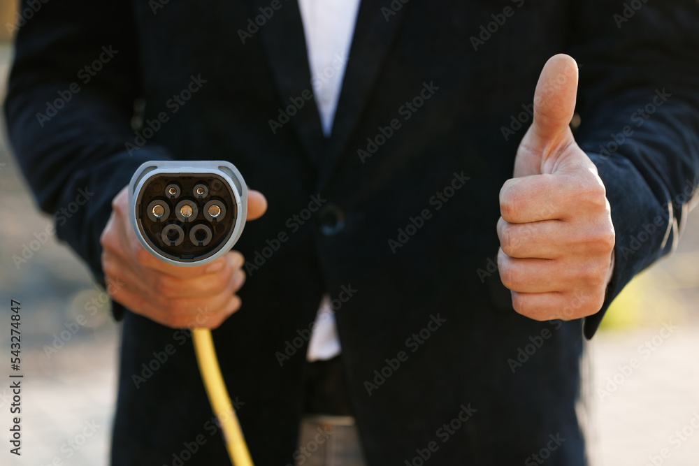 Businessman hand showing thumbs up holding power type 2 ccs cable ...