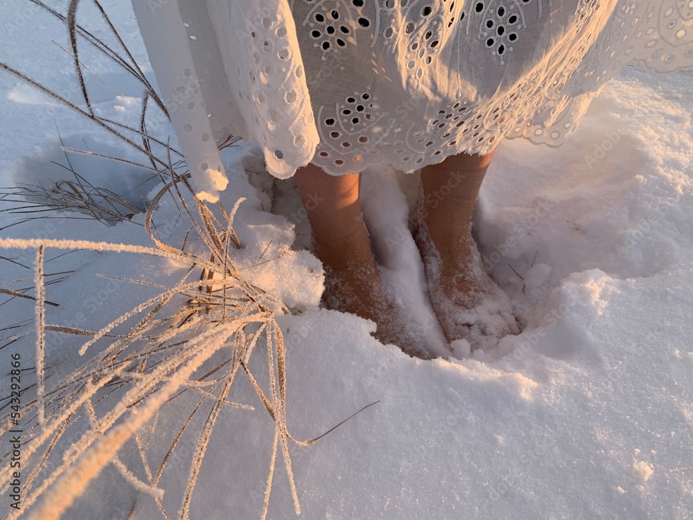 Walking barefoot in the snow. Women's feet. Hardening in the cold ...