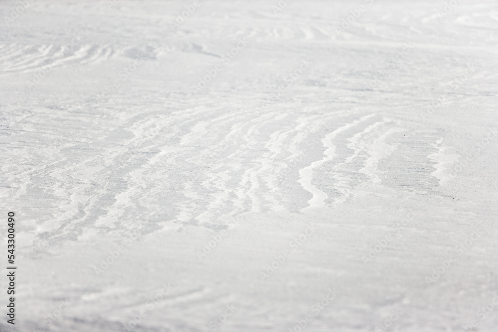 Winter snow forms ridges in frigid temperatures blowing wind. Stock ...