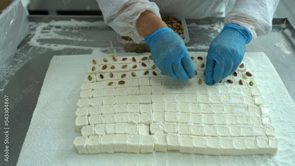 Close-up as a large batch of finished Turkish delight is emptied onto a ...