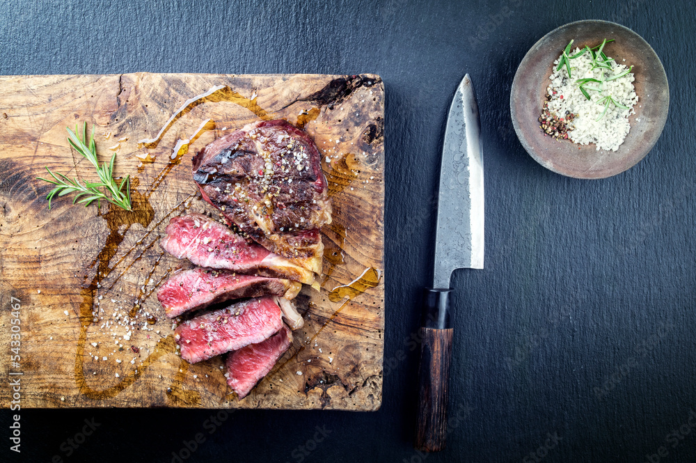 Barbecue dry agd angus rib-eye beef steak served as top view on a old ...
