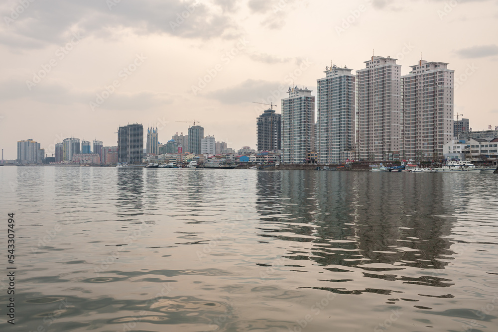 DANDONG, CHINA: the modern chinese city, seen from the Yalu river ...