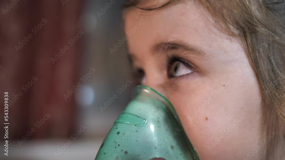 Mom treats her daughter with inhalation. Treating a child for a cold at ...