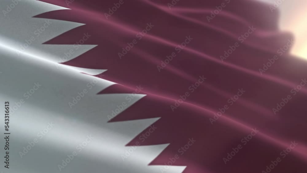 Waving the flag of the Middle Eastern country of Qatar. Fluttering the ...