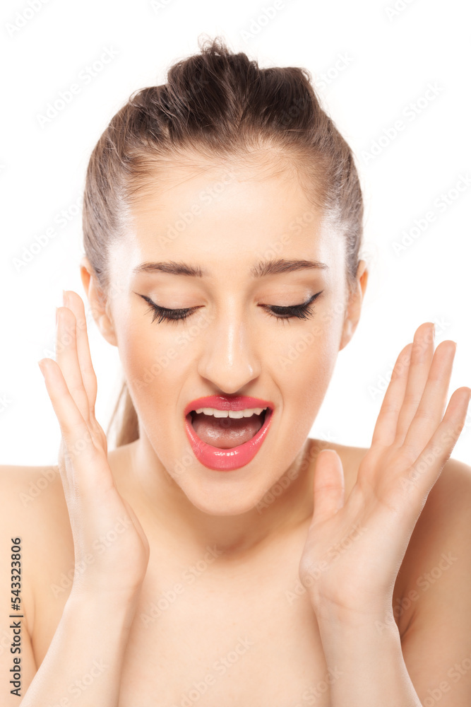 Beautiful girl studio portrait. Making hand gestures and face ...