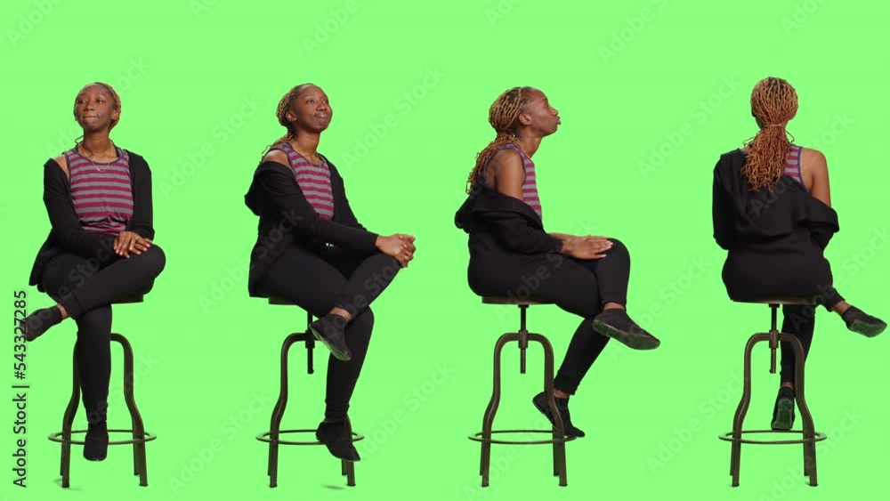 Positive smiling girl sitting on chair in four sides over full body ...