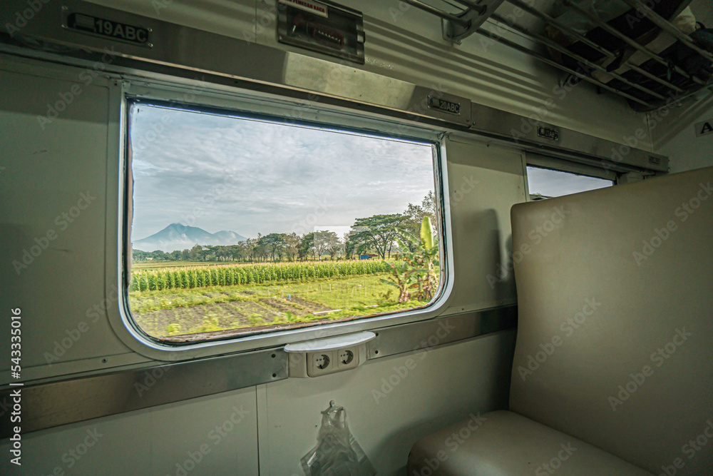 Fotka „Riding a train in Indonesia sitting by the window watching the ...