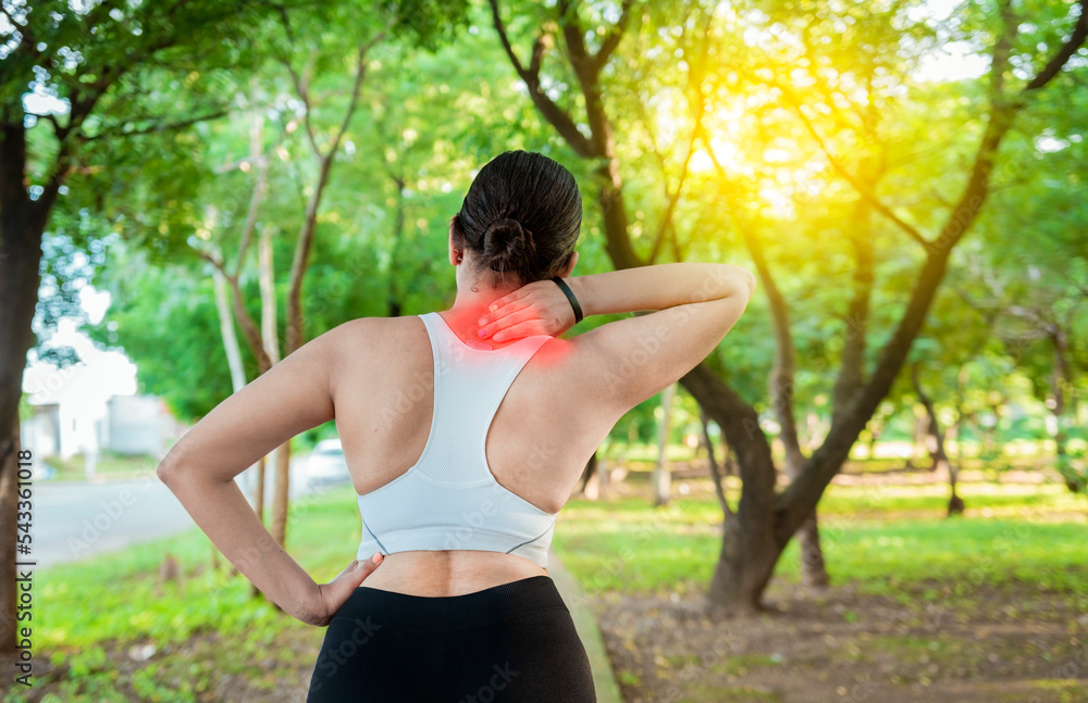 Running woman with shoulder muscle pain in a park. Shoulder pain ...