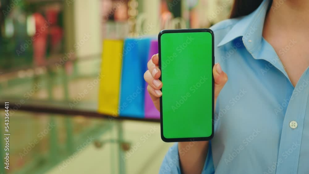 Close up of the woman hands holding the green screen on the shopping ...