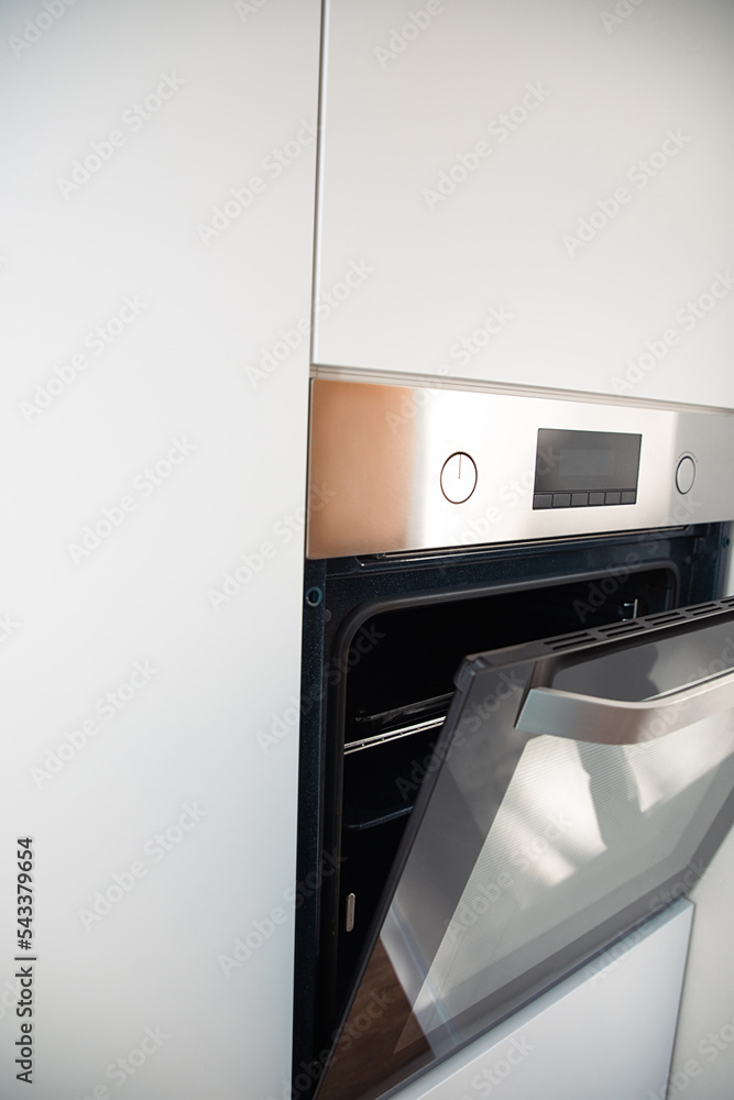Kitchen interior. A modern open oven built into a white kitchen. Front ...
