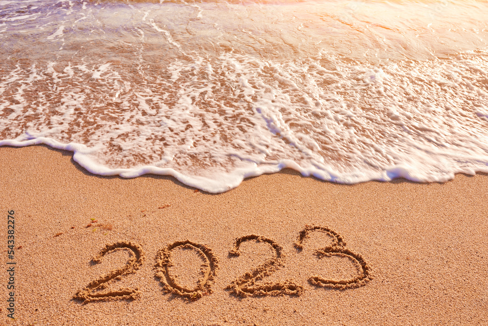 2023 year written on sandy beach sea at sunny day Stock Photo | Adobe Stock