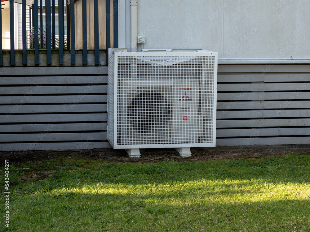 Mitsubishi air conditioner outdoor unit in metal mesh cage. Stock Photo ...