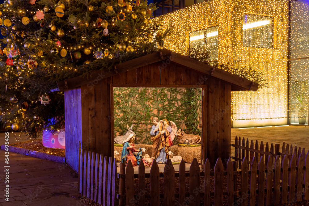Nativity scene with christmas crib showing the holy family at traditional Christkindlmarkt near ...