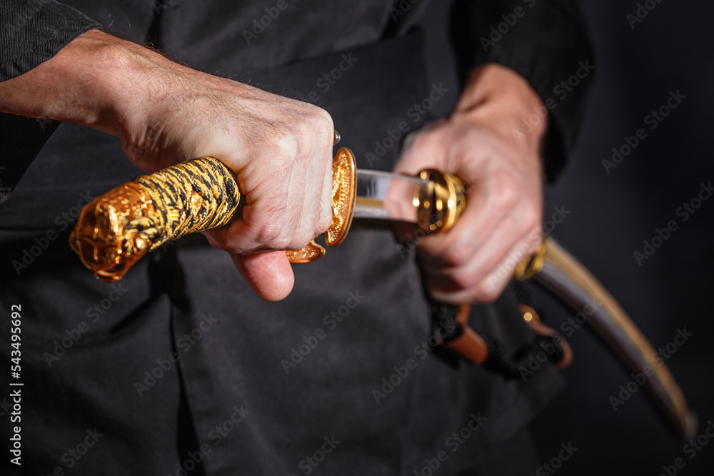 The samurai holding a Japanese katana sword. Photo of a warrior dressed ...