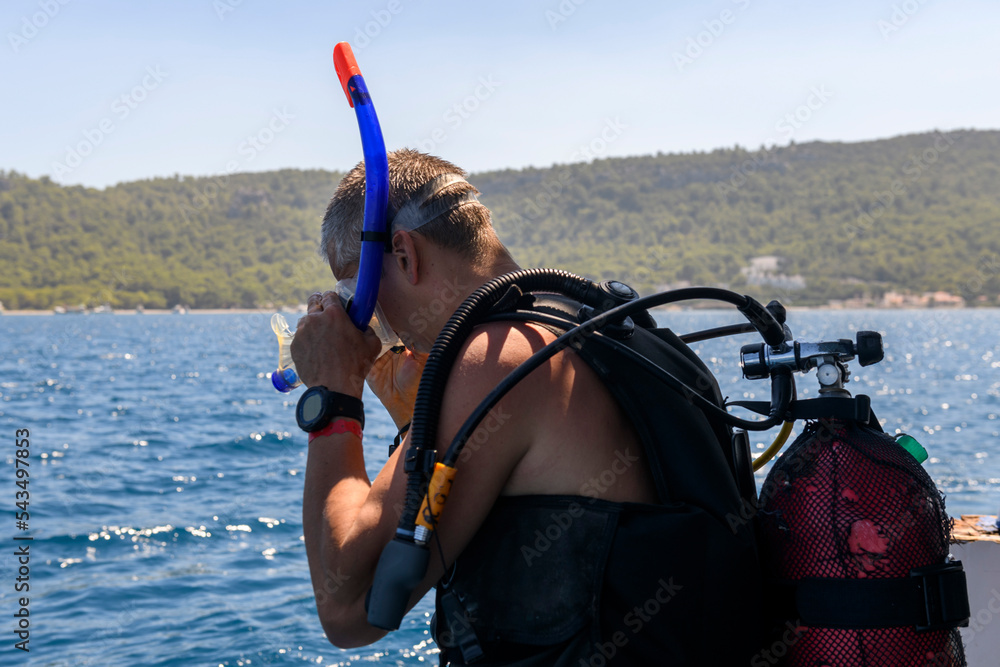 Male scuba diver preparing to dive. Wearing scuba. Caucasian man on ...