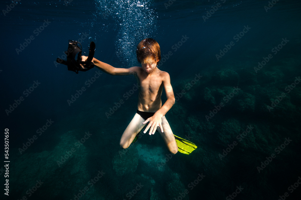 Full body of shirtless teenage guy in flippers with snorkeling mask in ...