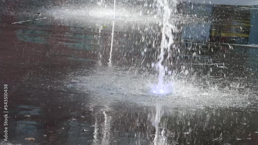 Slow-motion shot of two water fountains with purple light. Water ...