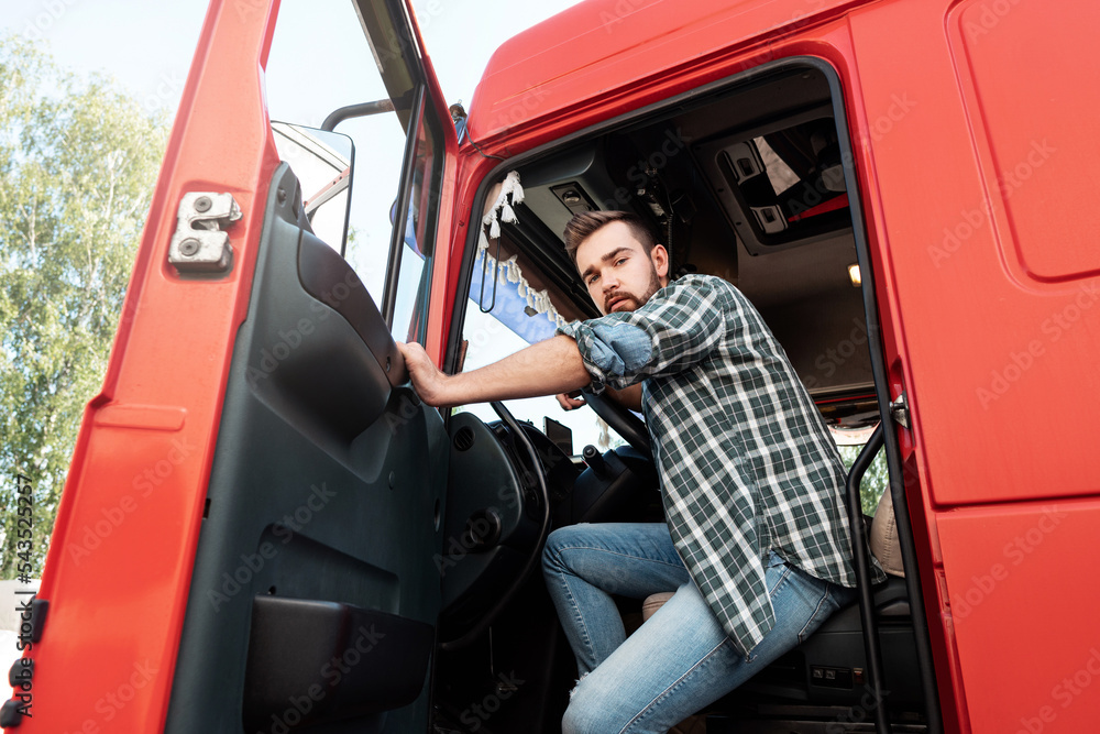Handsome bearded truck driver inside his red cargo truck Stock-Foto ...
