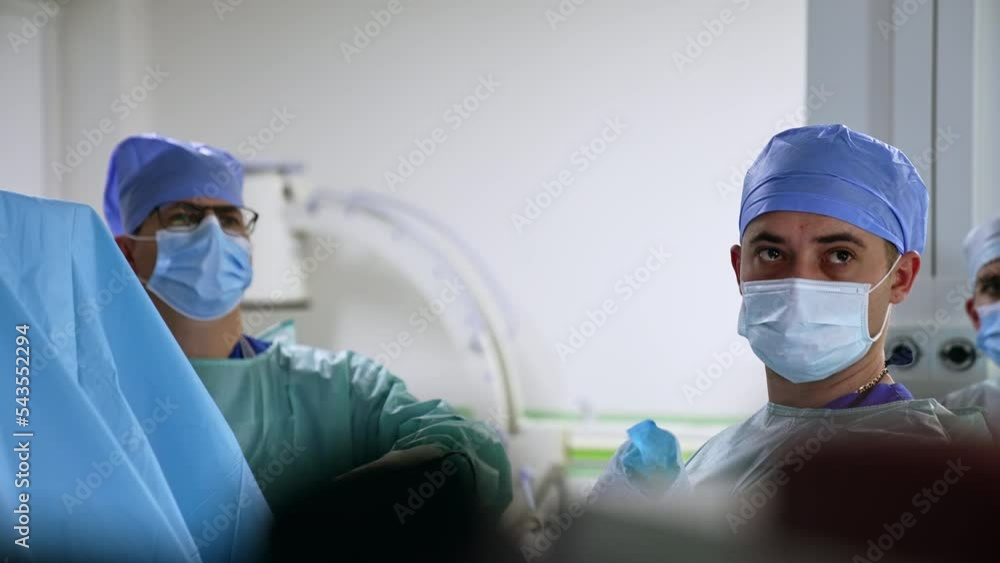 Chief surgeon moving slowly the device tool and looking intently on ...