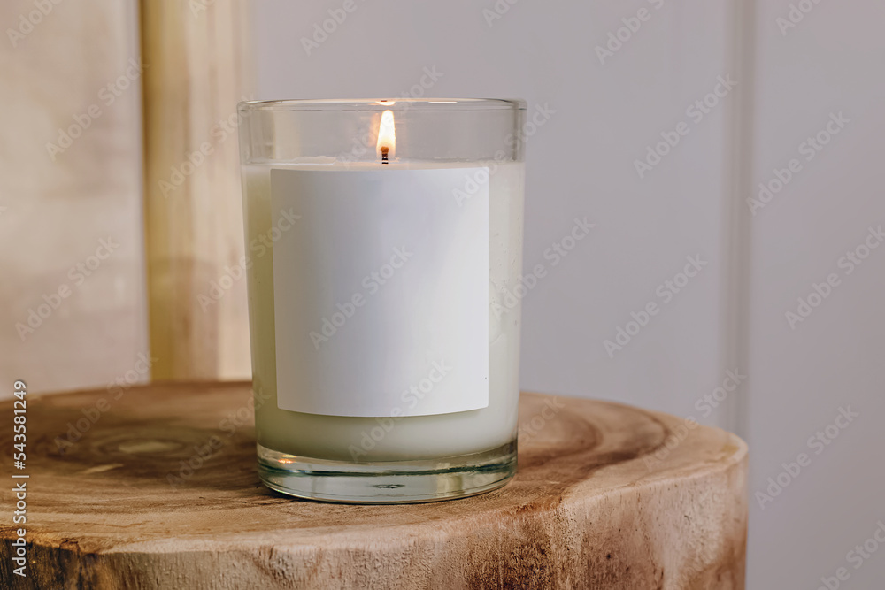 Burning candle with white empty label close-up Stock Photo | Adobe Stock