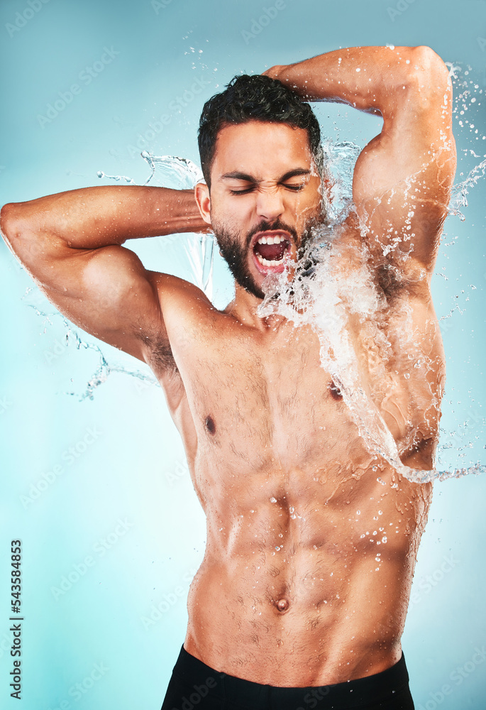 Body, water and shower with a muscle man in studio on a splash blue ...