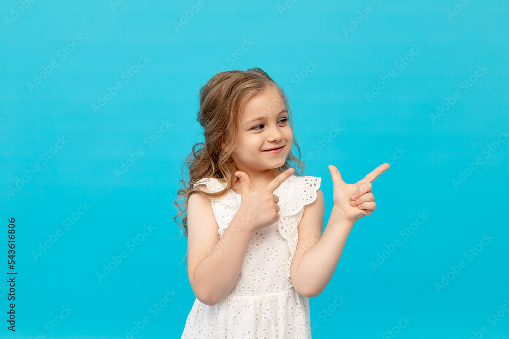Happy cute little girl in a cotton white dress on a blue background in ...