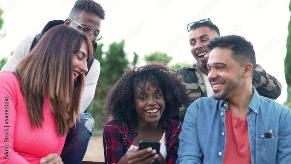 Surprised group of friends laughing while looking at mobile Stock Video ...