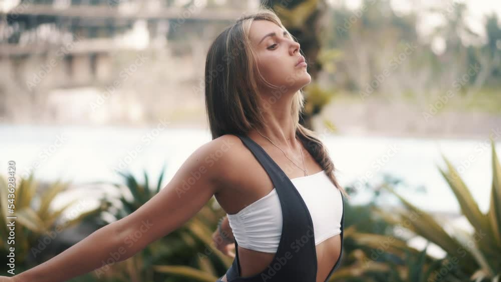 Every workout starts with warm-up. Young fit woman doing cross body arm ...