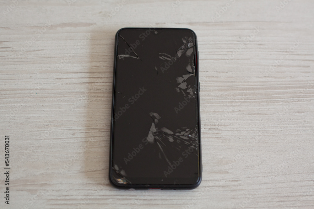 Mobile phone with a broken screen. The display glass of the smartphone ...