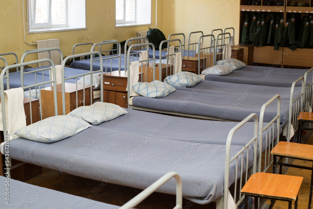 Soldier's beds in the barracks. A row of made beds in the Russian army ...
