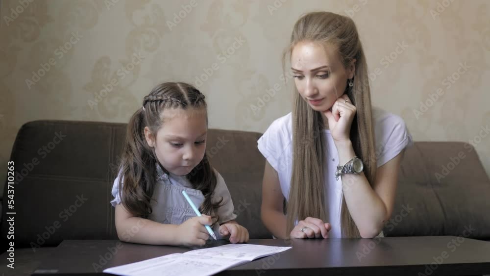 Mother and her preschool daughter do homework together at home, mom ...