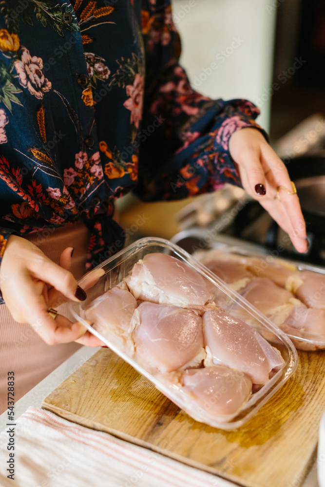 woman preparing raw organic chicken to cook in the skillet Stock Photo ...