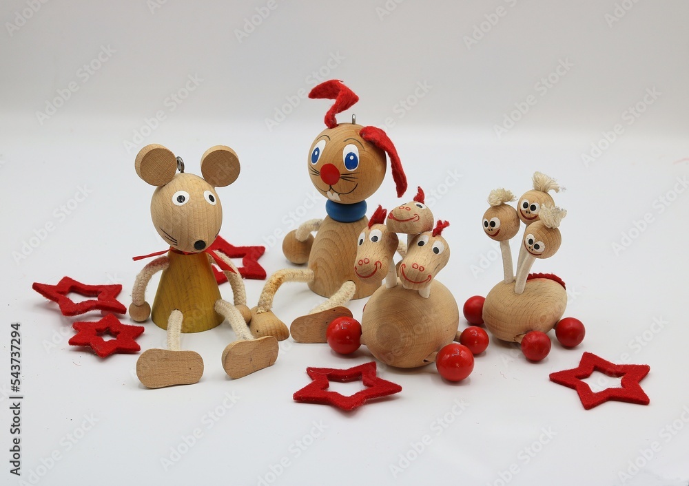 Traditional wooden toys, a mouse, a bunny and two little three-headed ...
