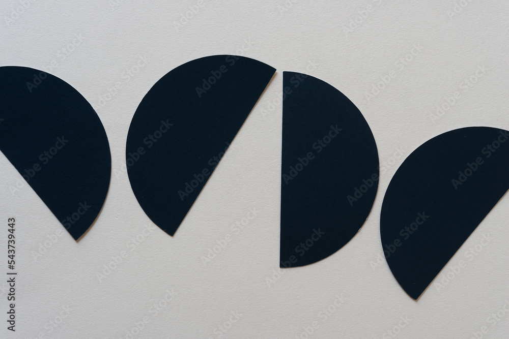 cut black paper semi circle shapes on blank paper Stock Photo | Adobe Stock