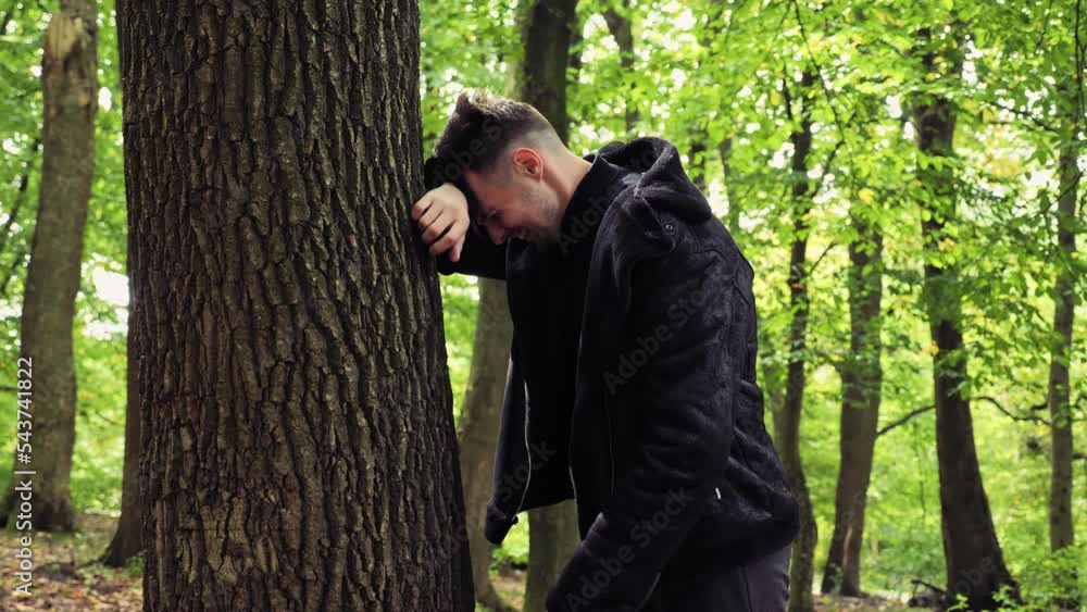 Vidéo Stock Upset male face of sad stressed man standing near tree in ...