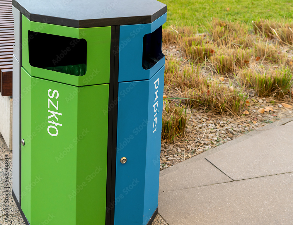 Black, blue, yellow, green garbage recycling bins on street in city ...