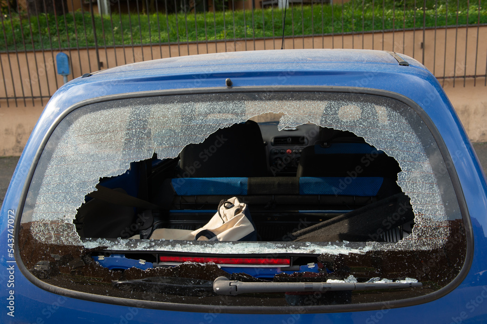 Rear window shattered in car parked in street parking. Thieves broke ...