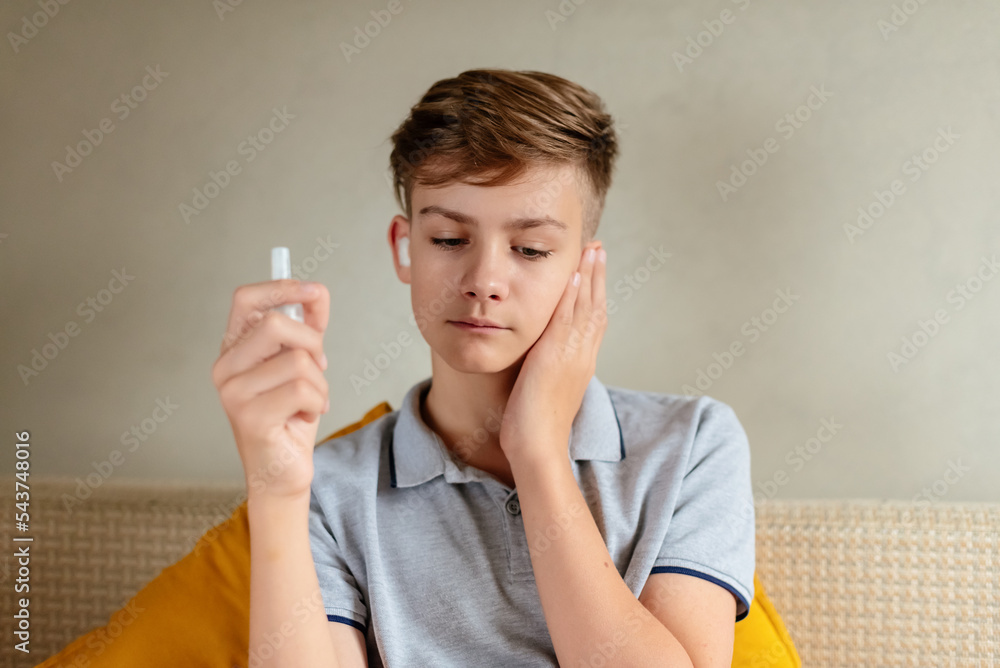 Teen boy suffering from strong earache or ear pain. Ear inflammation ...