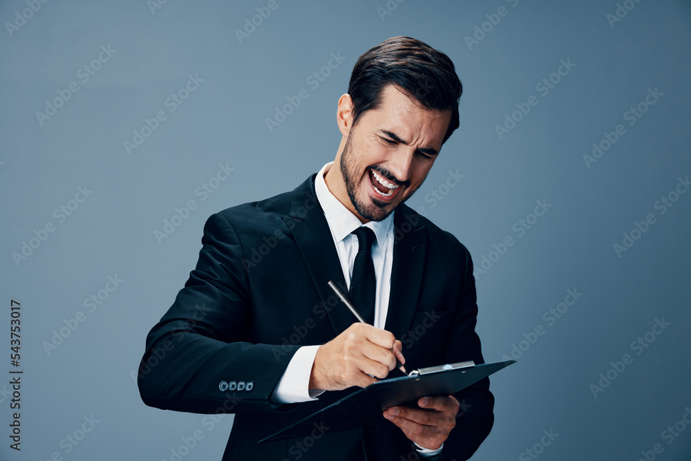 An angry business man with a headache is holding a folder of notes in ...